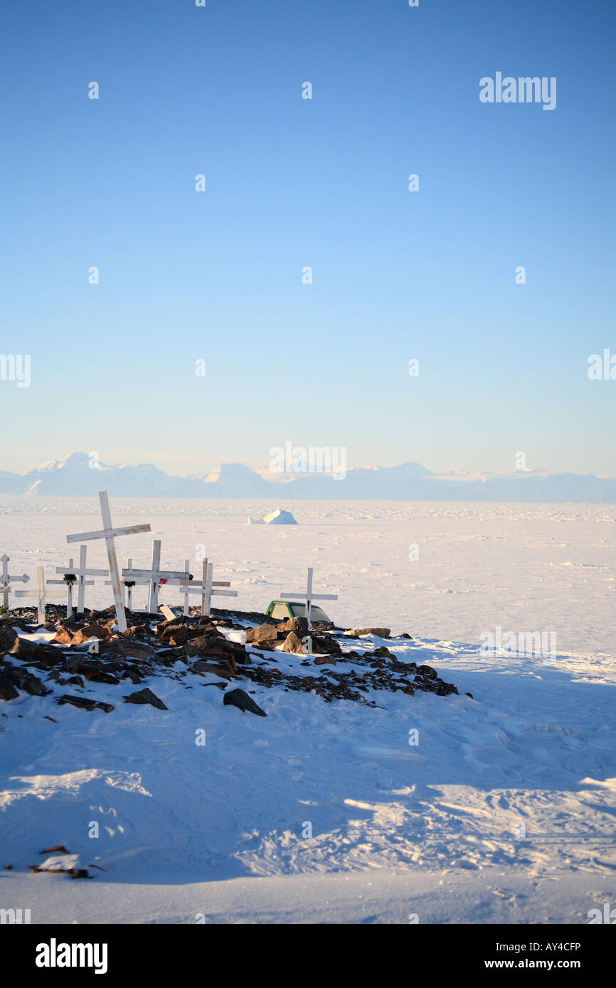 Graveyard overlooking frozen sea ice, Ittoqqortoormiit, East Greenland ...