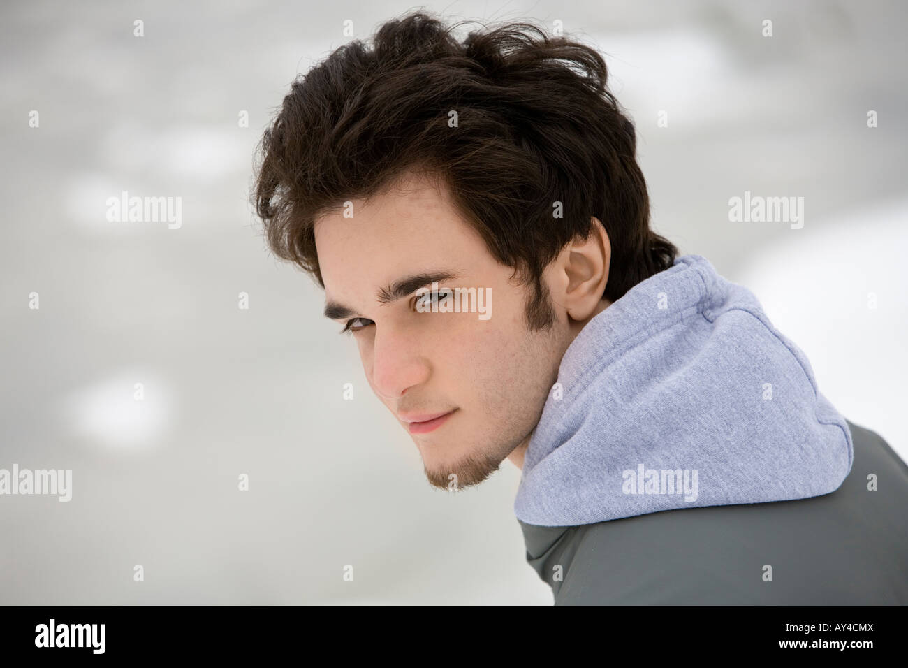 Young Man stands outside It is winter time and he wears a coat Stock ...