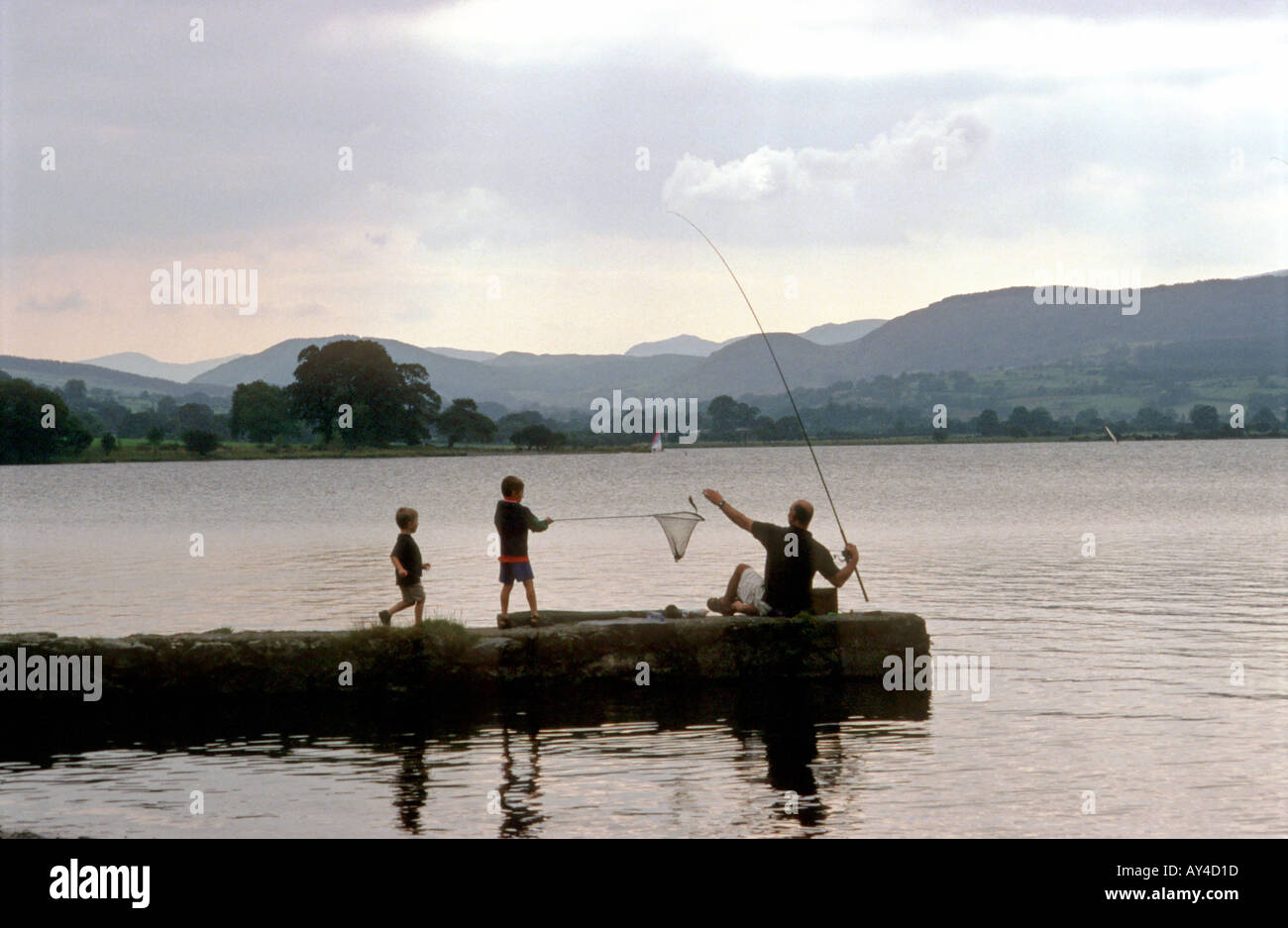 Man two boys catching fish Stock Photo - Alamy