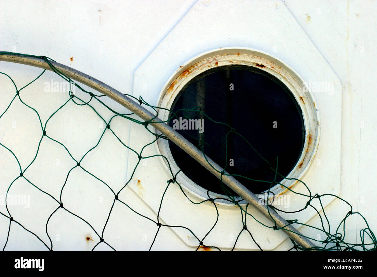 Porthole and net on fishing boat Stock Photo - Alamy