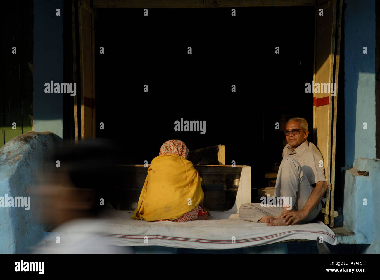 Man sitting outside shop in street in Bundi Rajasthan. India Stock ...