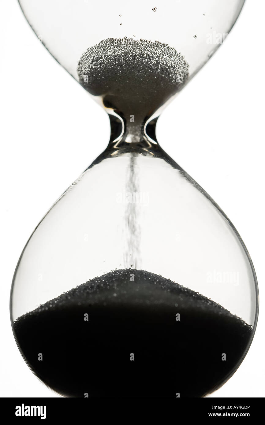 sand slipping through hourglass Stock Photo - Alamy
