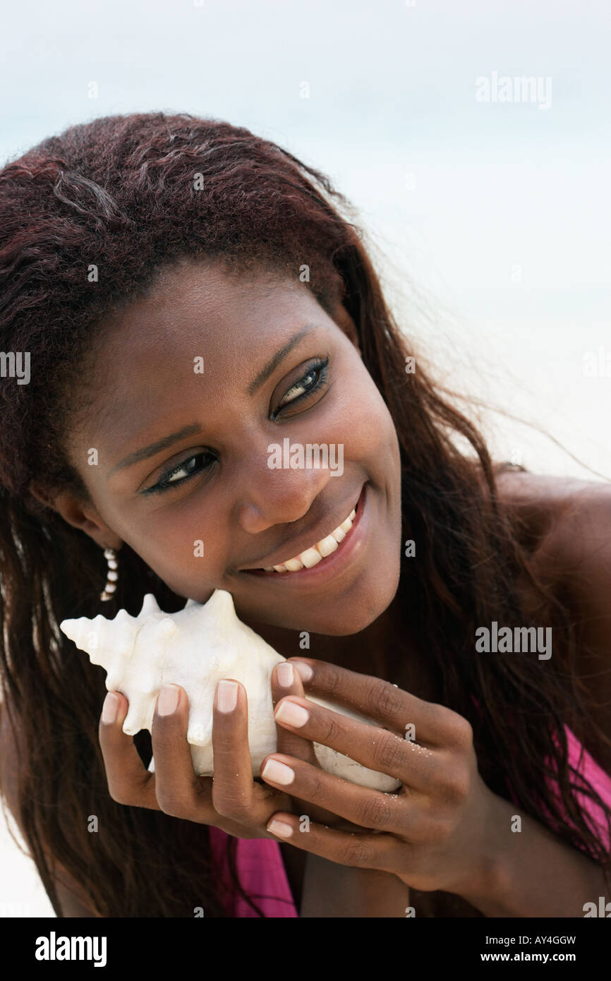 South American woman holding seashell Stock Photo - Alamy