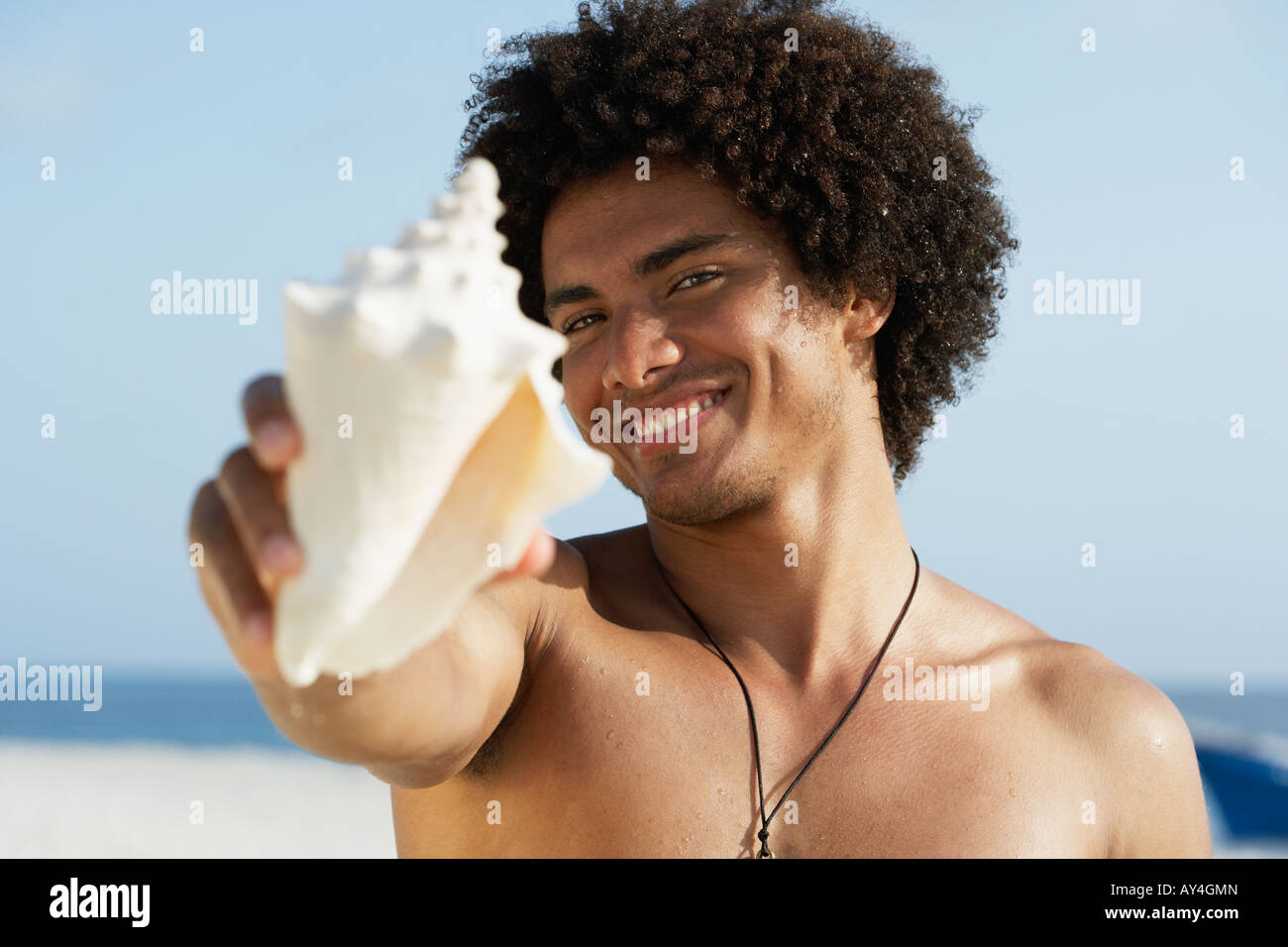South American man holding seashell Stock Photo - Alamy