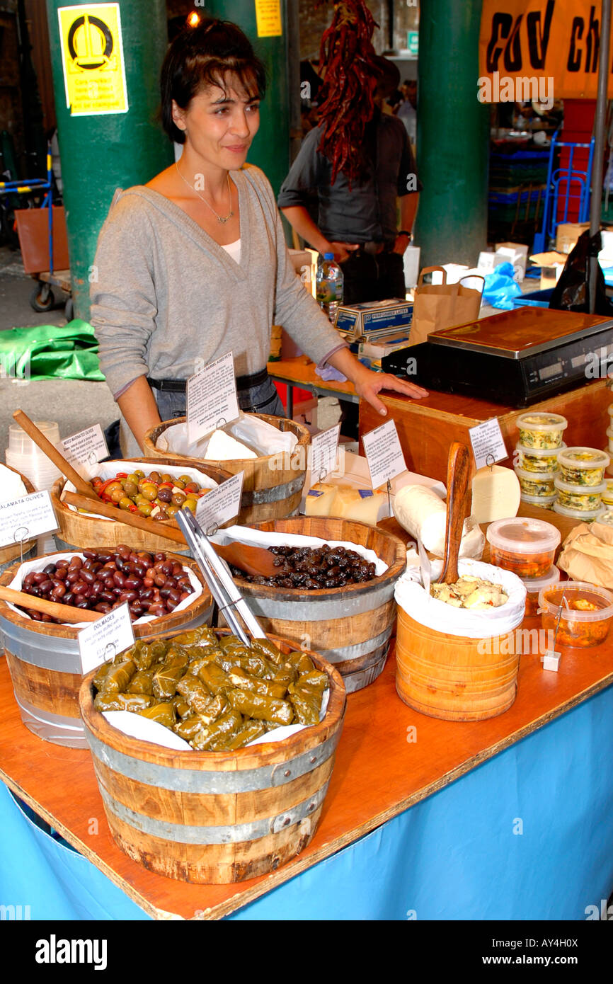 Beautiful smiling Greek lady serves stuffed vine leaves kalamata ...