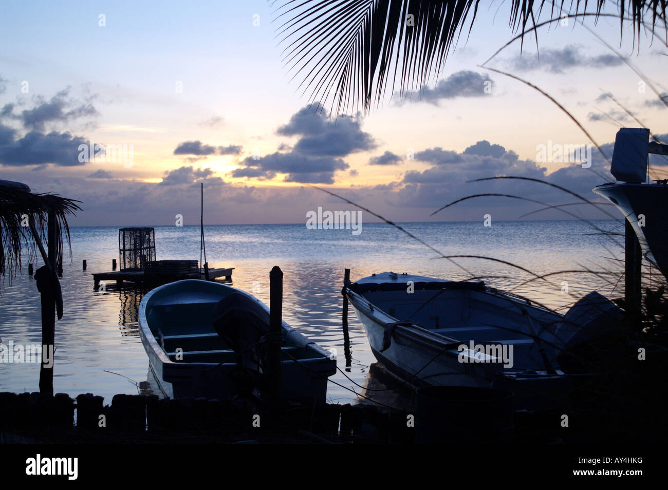 sunset with boats in foreground, Caye Caulker Belize Stock Photo - Alamy