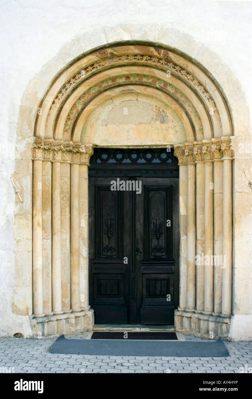 Entrance into the old gothic roman style church Stock Photo - Alamy