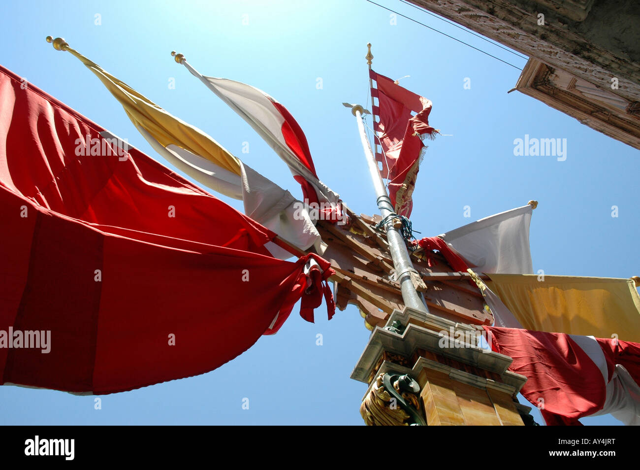 A low view of some flags decorating the streets during a village feast ...