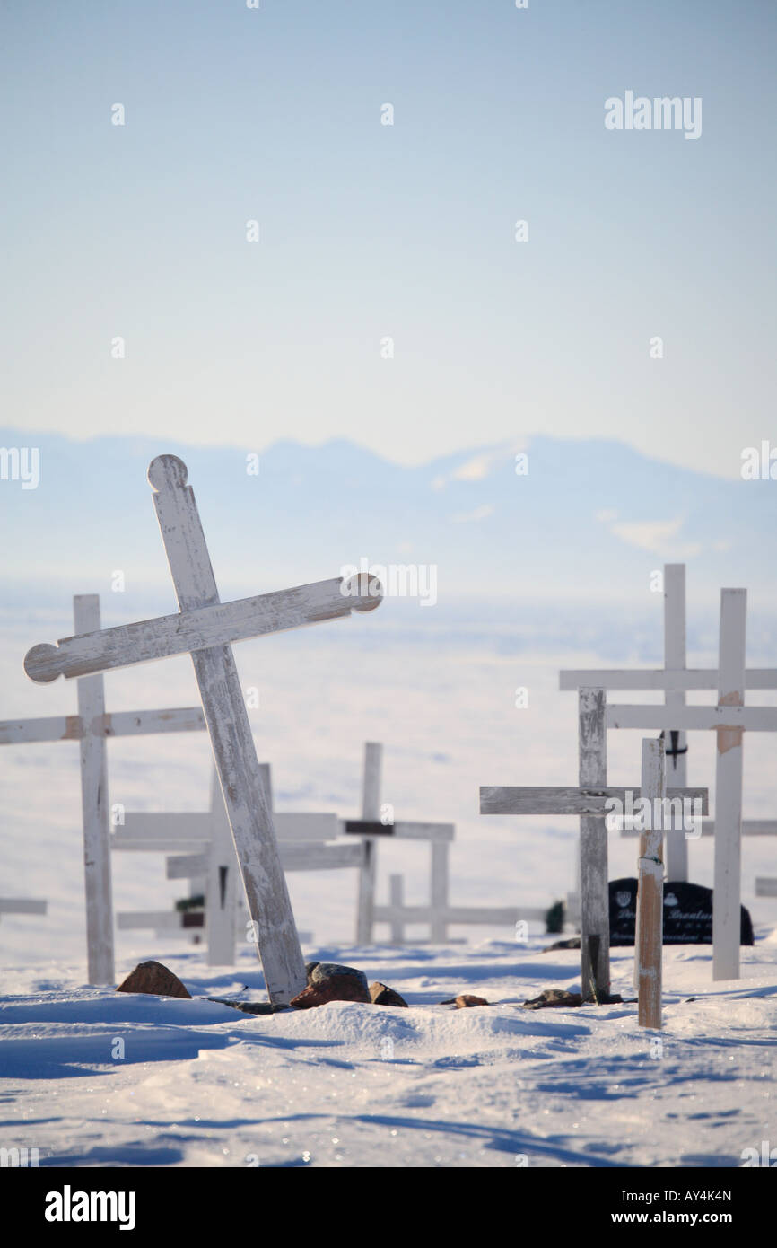 Graveyard overlooking frozen sea ice, Ittoqqortoormiit, East Greenland ...