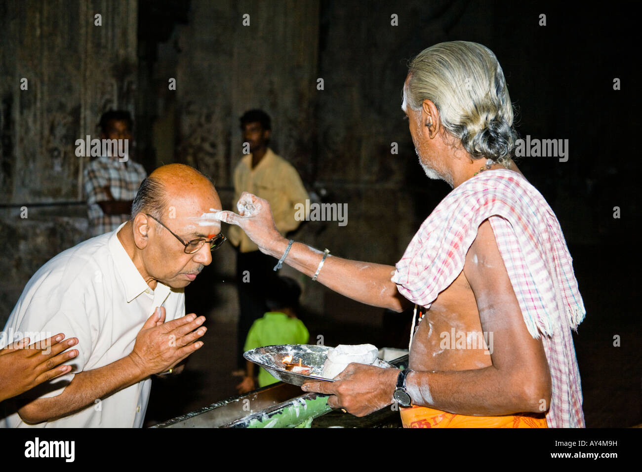 Brahmin applying a tikka to a man’s forehead, Meenakshi Temple, Madurai ...