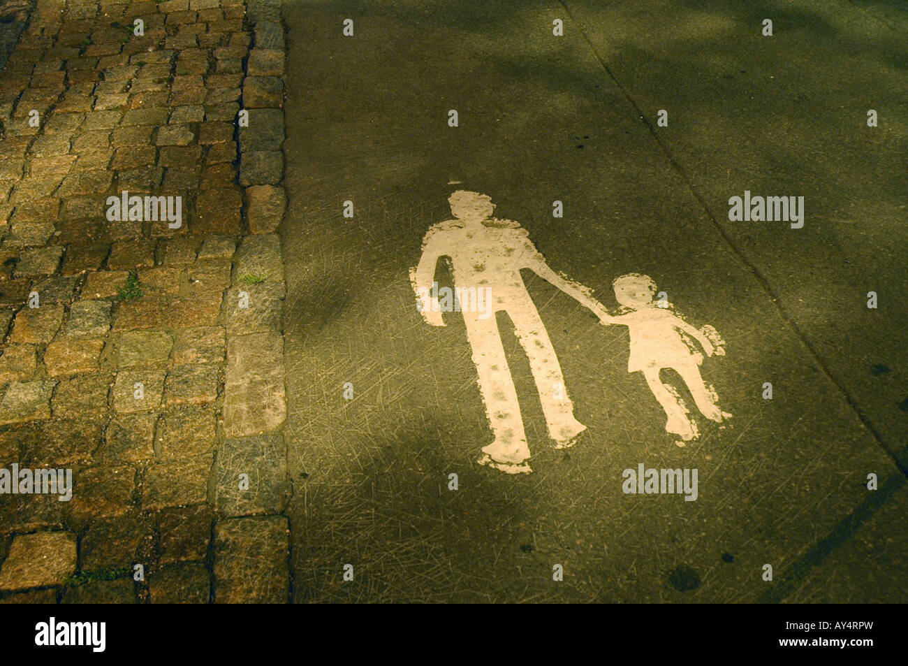 a print of an adult holding a child's hand indicating the walking ...