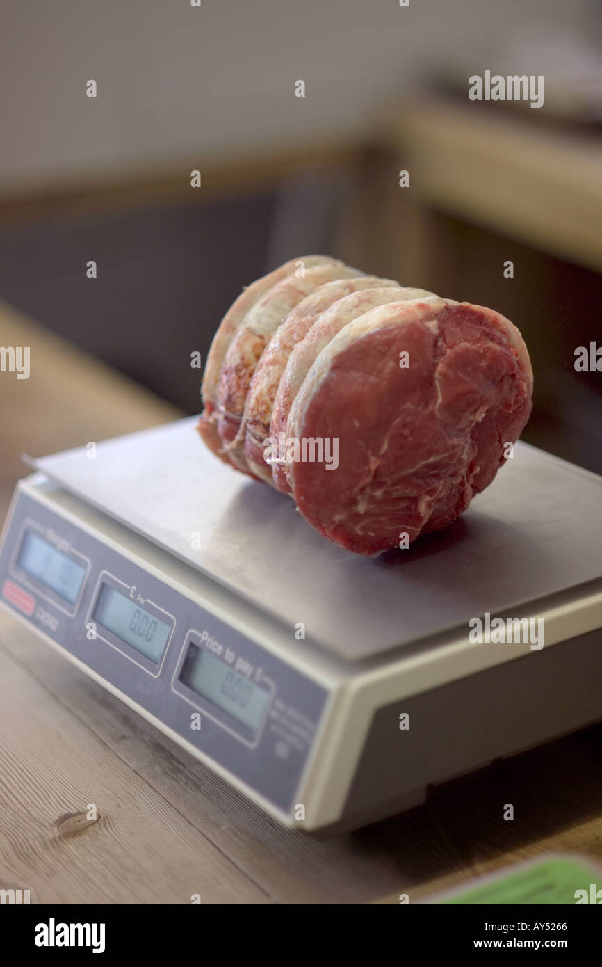 joint of meat on scales in a butchers shop Stock Photo - Alamy