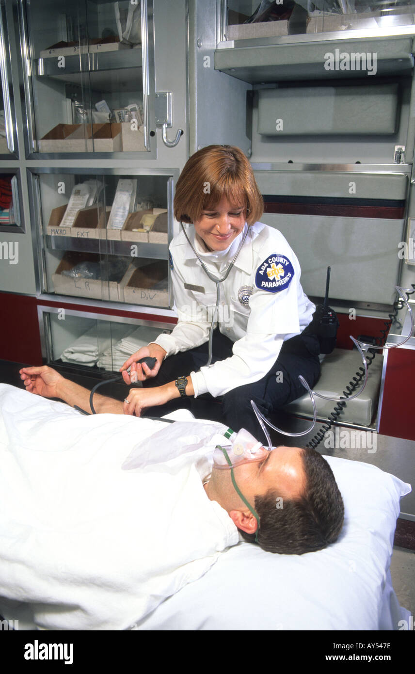 Female paramedic with patient inside an ambulance Stock Photo - Alamy