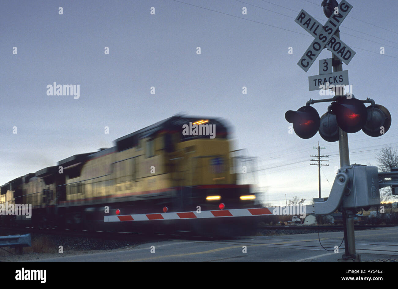 A train passes in front of a railroad crossing sign and arm Stock Photo ...