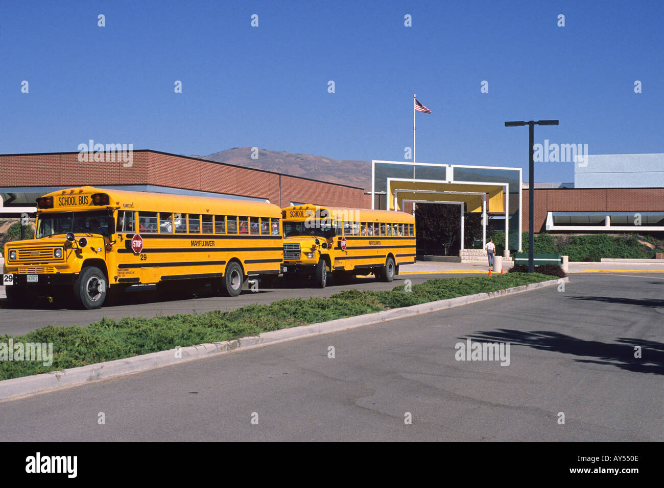 School buses parked in front of an elementary school Stock Photo - Alamy