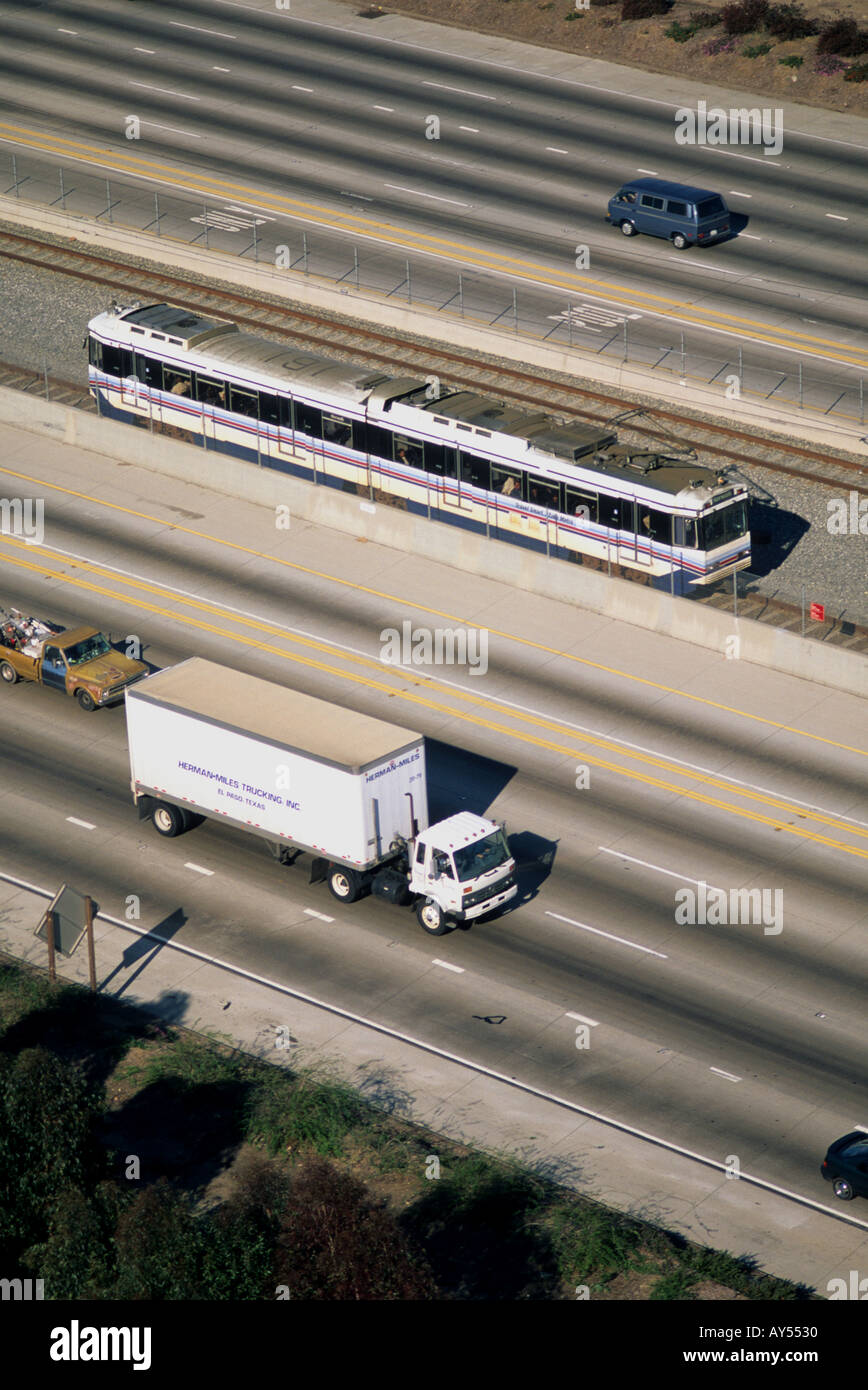 Metro train and traffic on the highway in Los Angeles California Stock ...