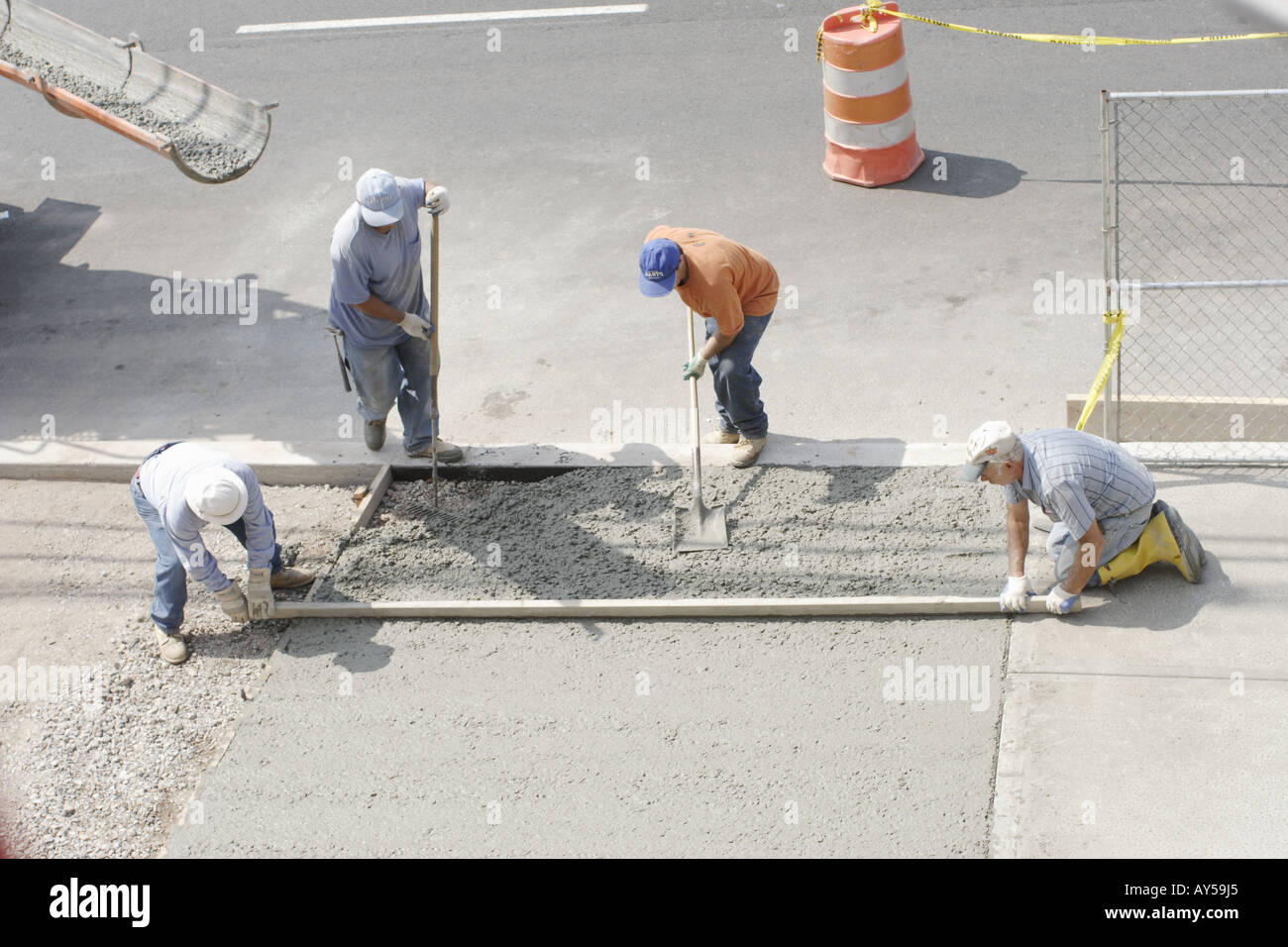 Workers pouring cement for a sidewalk Stock Photo - Alamy