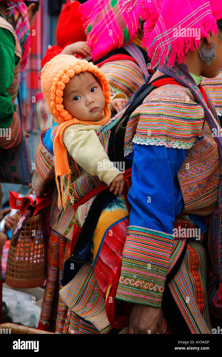 Flower Hmong baby in a sling on her mothers back Stock Photo - Alamy