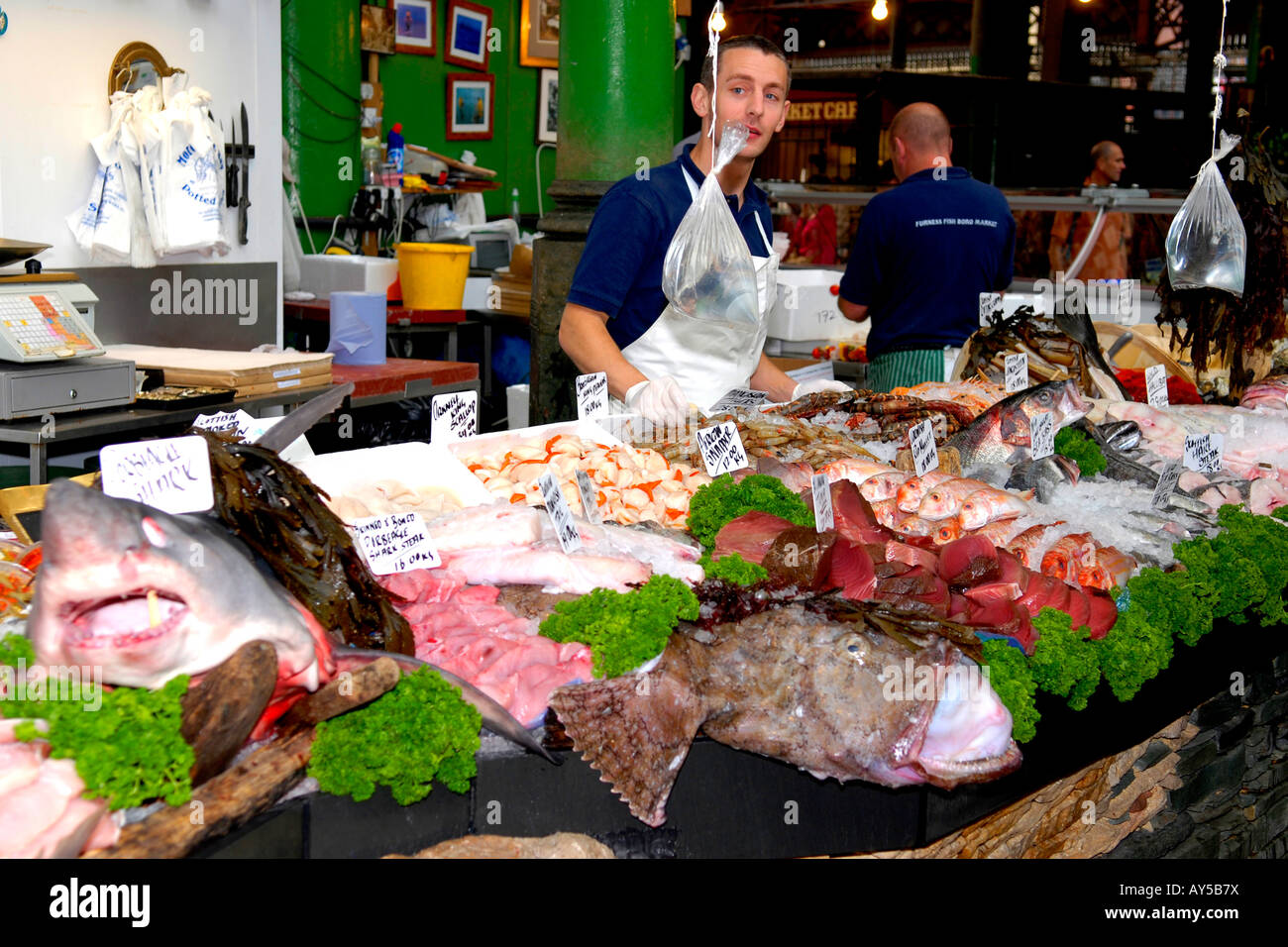 Fresh wet fish stall selling tuna monkfish , trout scallops , squid ...