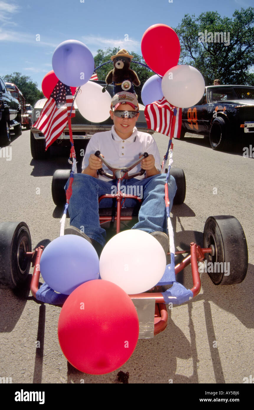 A go-kart covered with patriotic red, white and blue balloons in the ...
