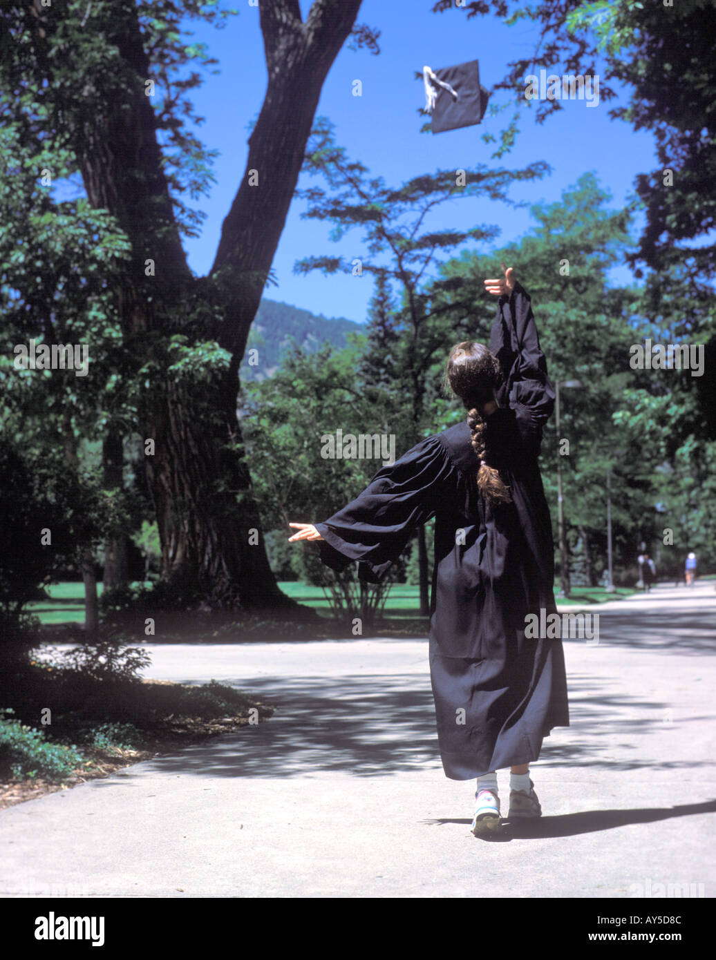 graduate throwing her cap in the air Stock Photo - Alamy