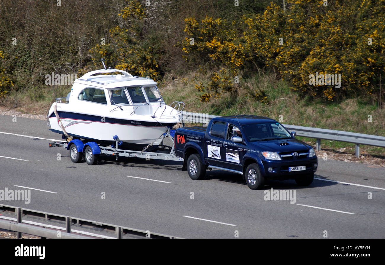 Four wheel drive vehicle towing cabin cruiser on M40 motorway, UK Stock ...