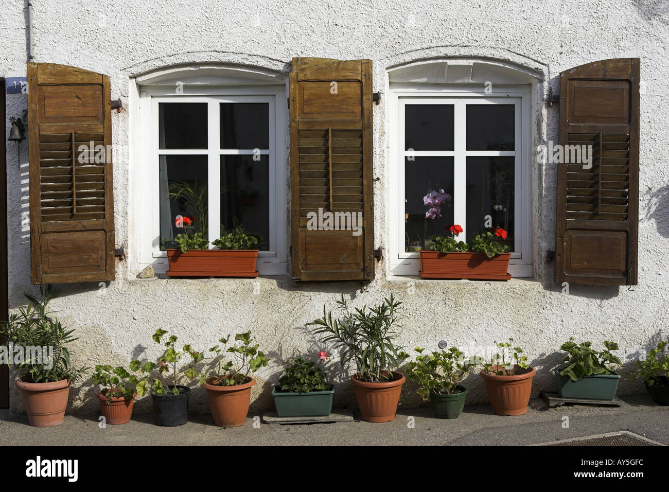 White walled house with shuttered windows and plant pots Hesse France ...