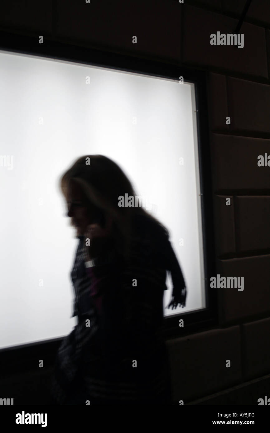 person passing neon light at night Stock Photo - Alamy