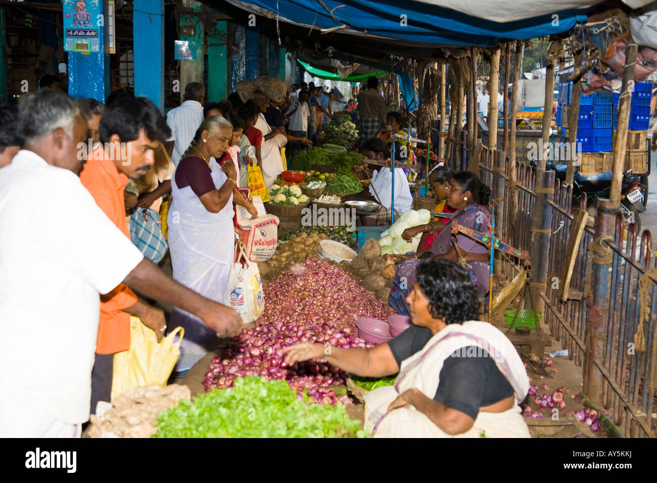 People buying vegetables in a covered street market, Madurai, Tamil ...