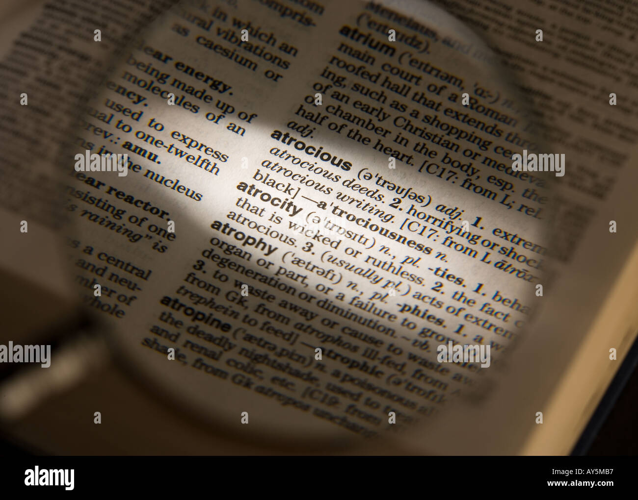 MAGNIFYING GLASS ON DICTIONARY PAGE SHOWING DEFINITION OF THE WORD ...