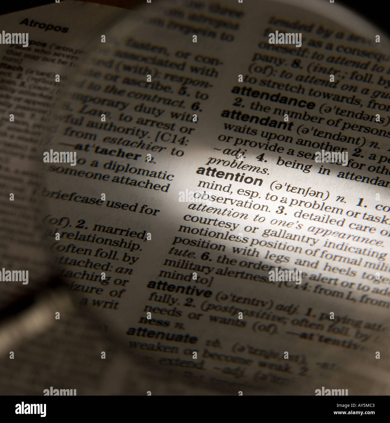 MAGNIFYING GLASS ON DICTIONARY PAGE SHOWING DEFINITION OF THE WORD ...