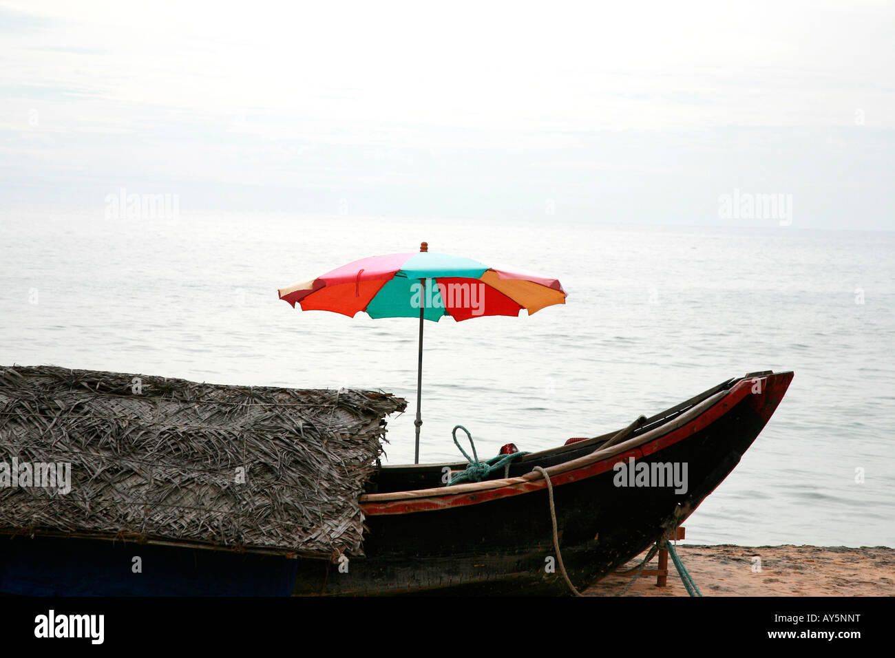 boat and umbrella at kovalam beach,kerala,india Stock Photo - Alamy