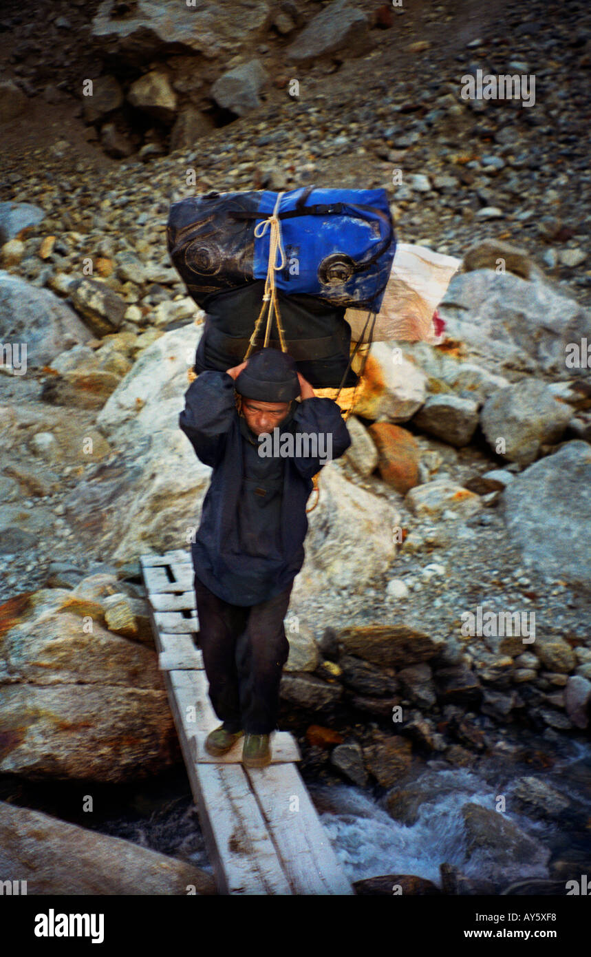 Porter carrying heavy load Stock Photo - Alamy