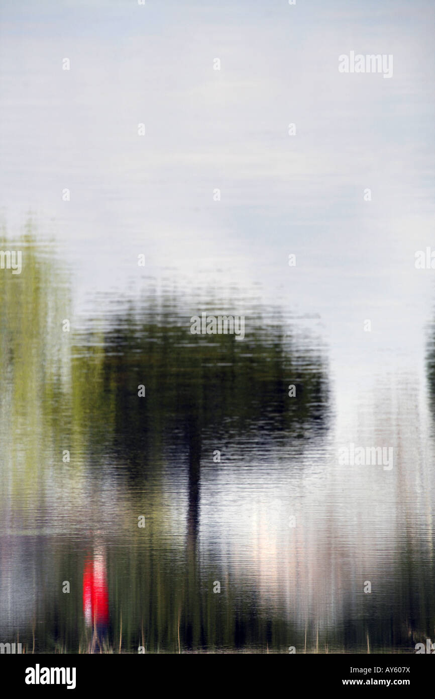 reflection of man walking by lake Stock Photo - Alamy
