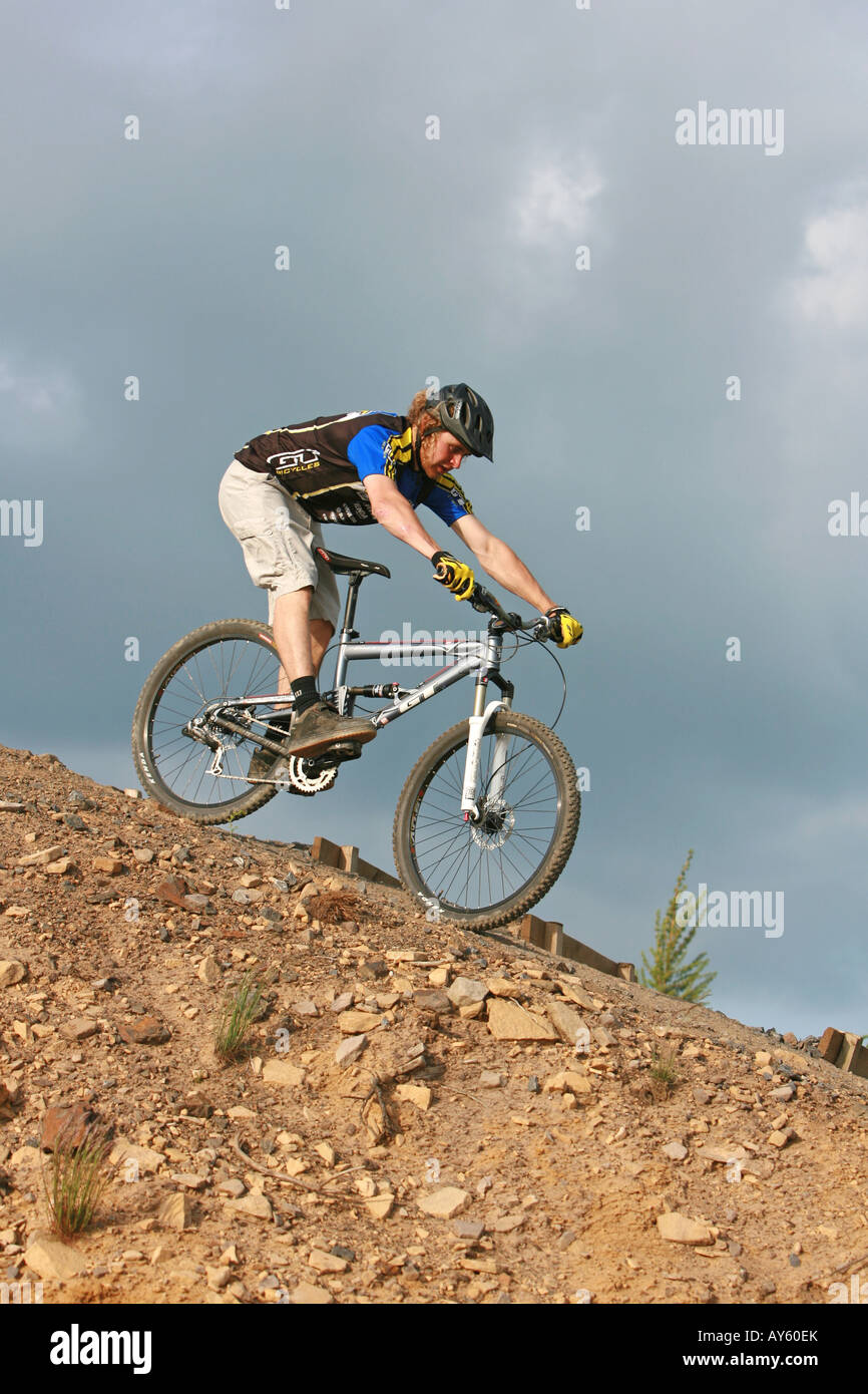 A mountain biker rides his mountain bike down a rocky slope Stock Photo ...