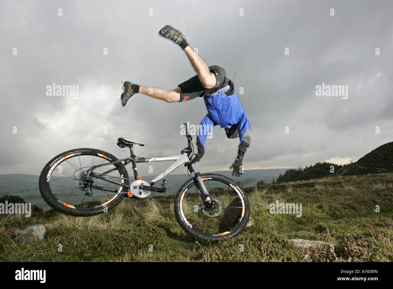 A mountain biker crashing with his mountain bike Stock Photo - Alamy