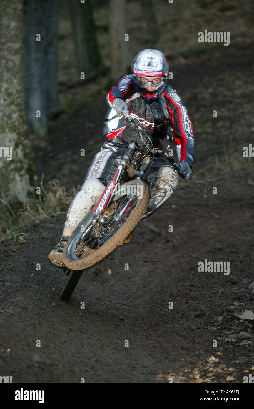 A mountain biker wheelies his bike along a dirt track Stock Photo - Alamy