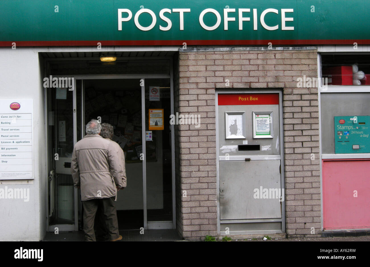 man going into village post office Stock Photo - Alamy