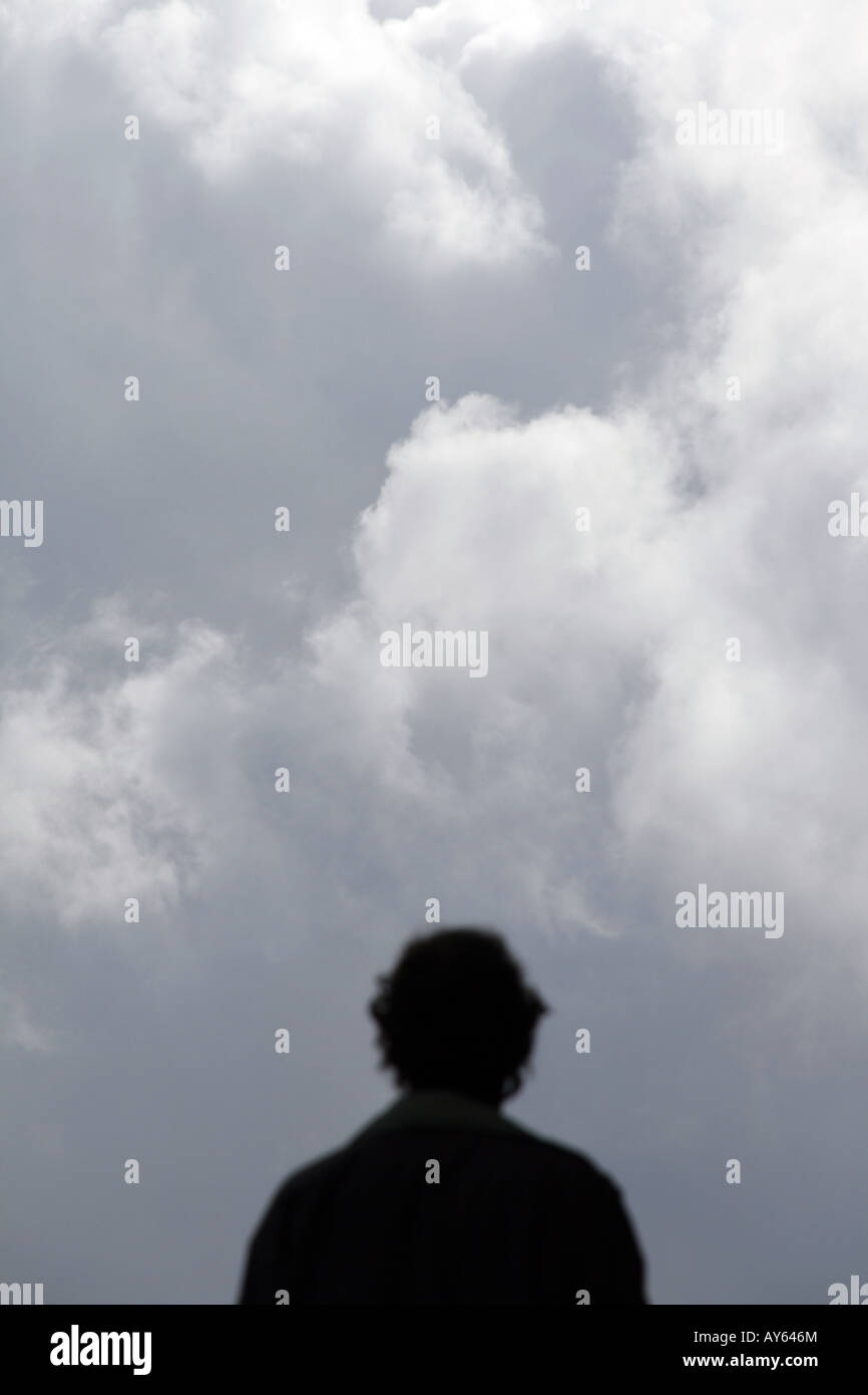 backlit person against dramatic sky Stock Photo - Alamy