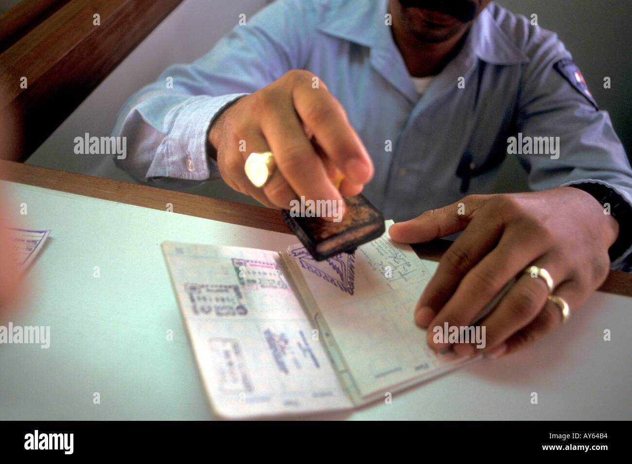 Customs Official Stamping Passport in the Caribbean Stock Photo - Alamy
