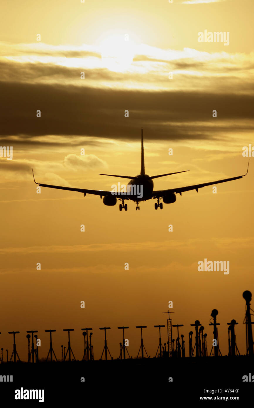 Boeing 737 aircraft landing at Stansted airport at sunset Stock Photo ...