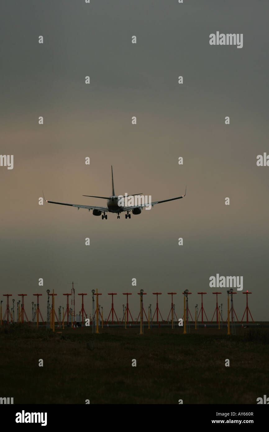 Boeing 737 aircraft landing at Stansted airport at sunset Stock Photo ...