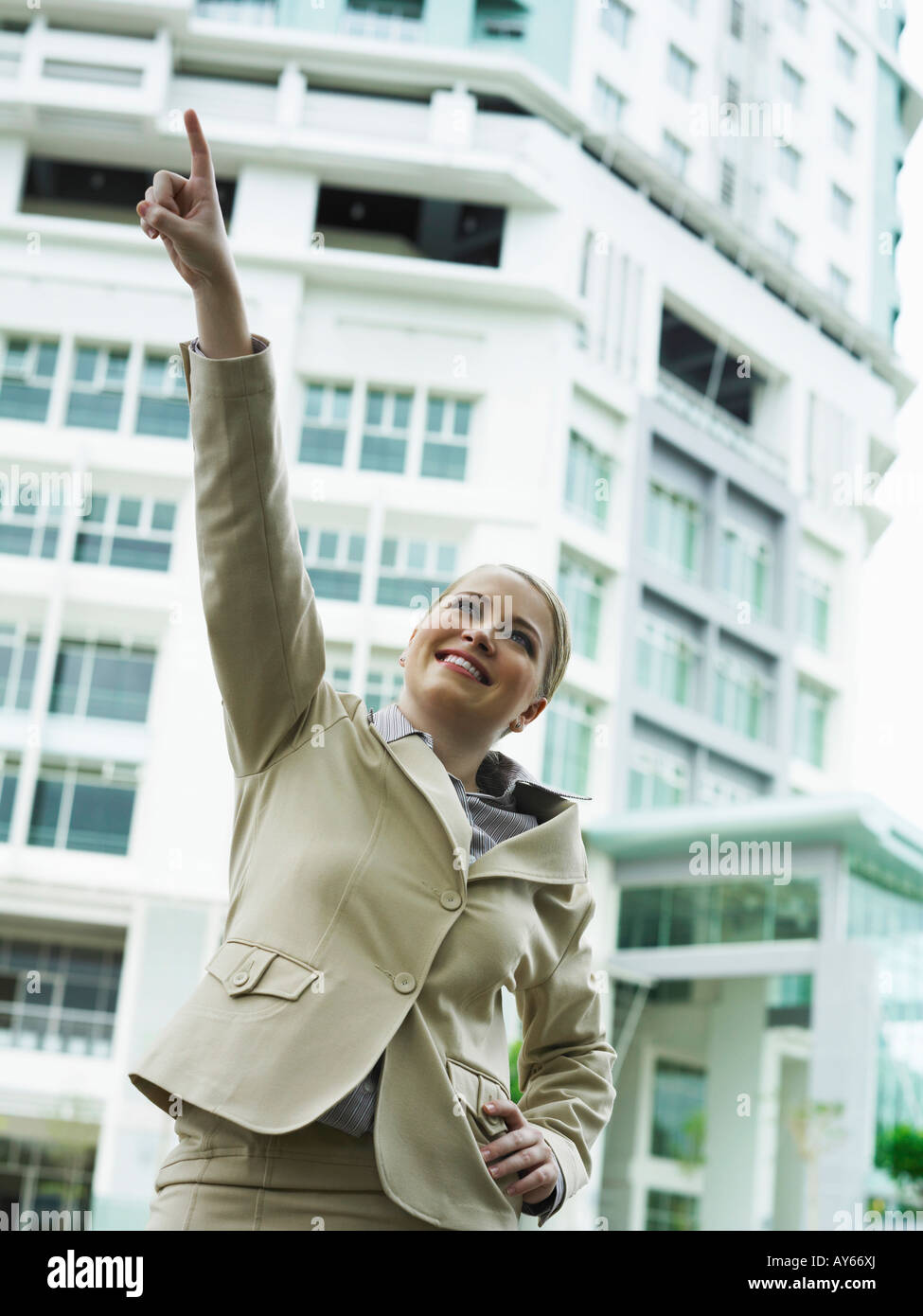 A business woman pointing over something in the sky Stock Photo - Alamy