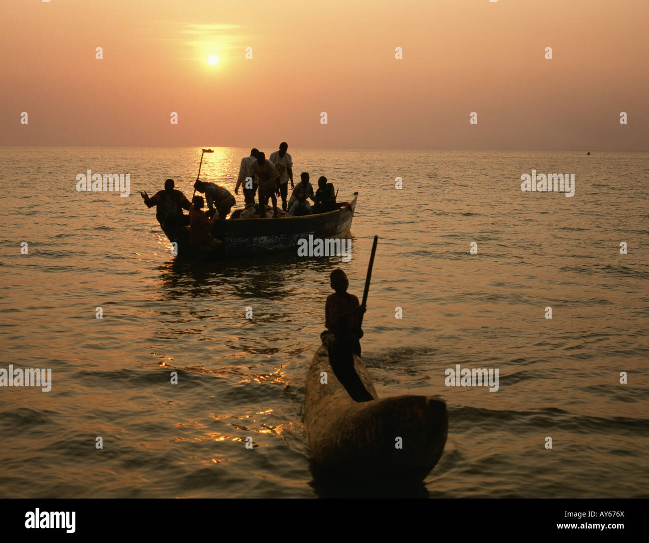 Lake Malawi Sunset orange sky Light reflecting on water People ...