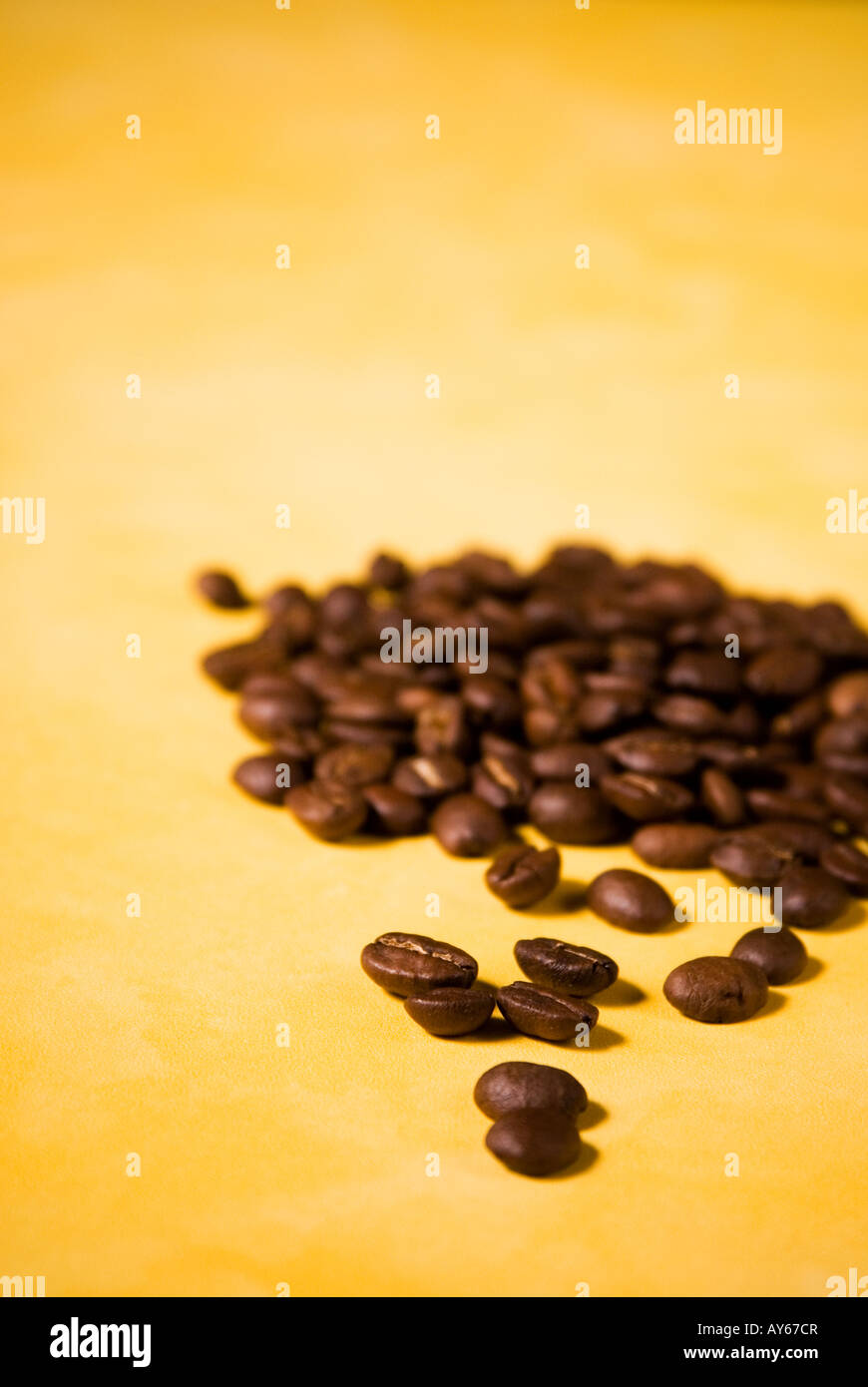 Roasted coffee beans on yellow background Stock Photo - Alamy