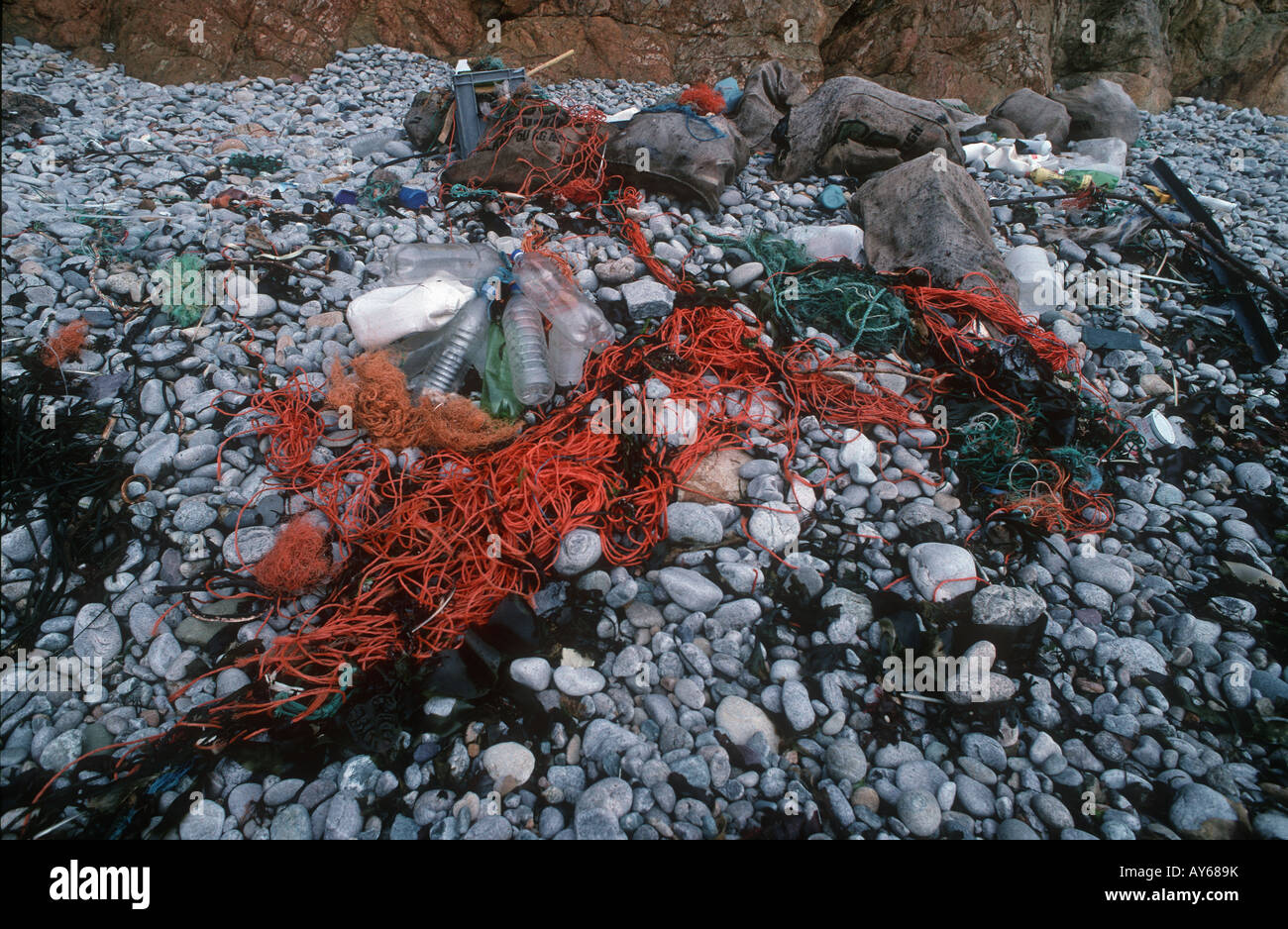 Nylon netting and plastic bottled washed up on Porthllysksy beach St ...