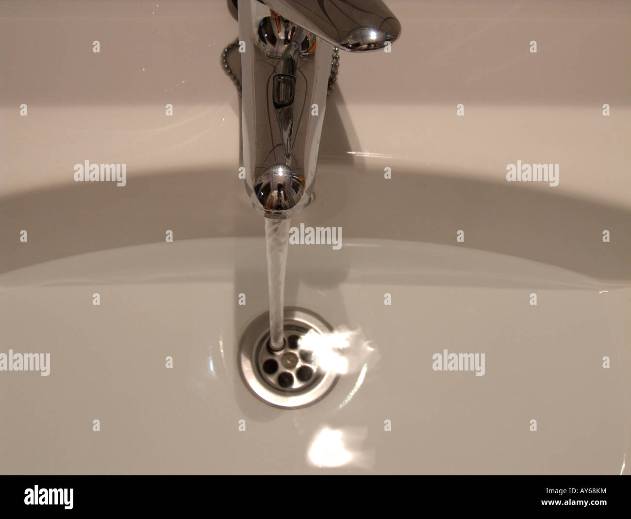 Faucet opened wasting water Stock Photo - Alamy