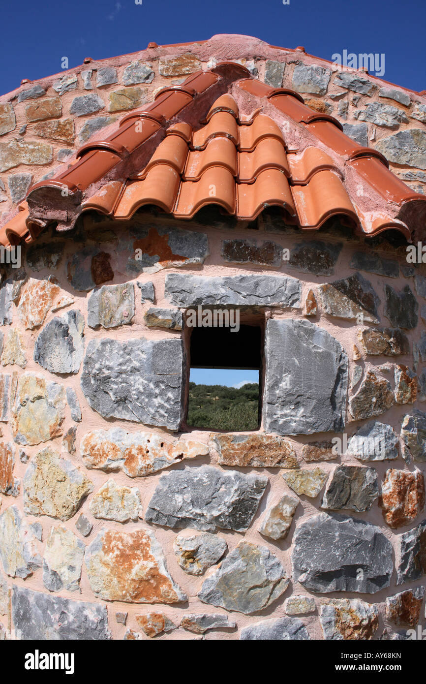 traditional fieldstone built chapel with window in field of oil trees ...