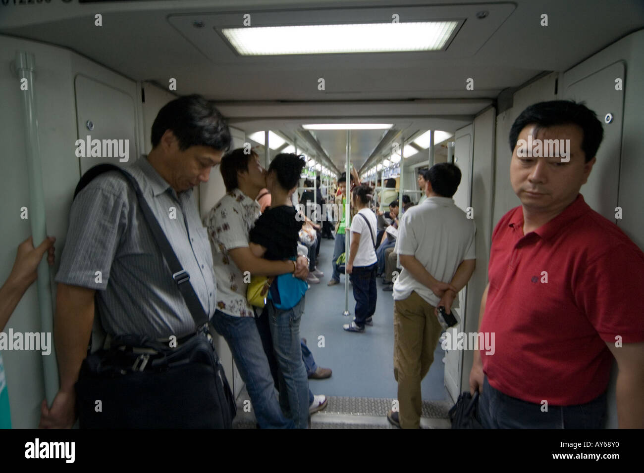 The subway riders in the subway rail car, two lovers passengers are ...