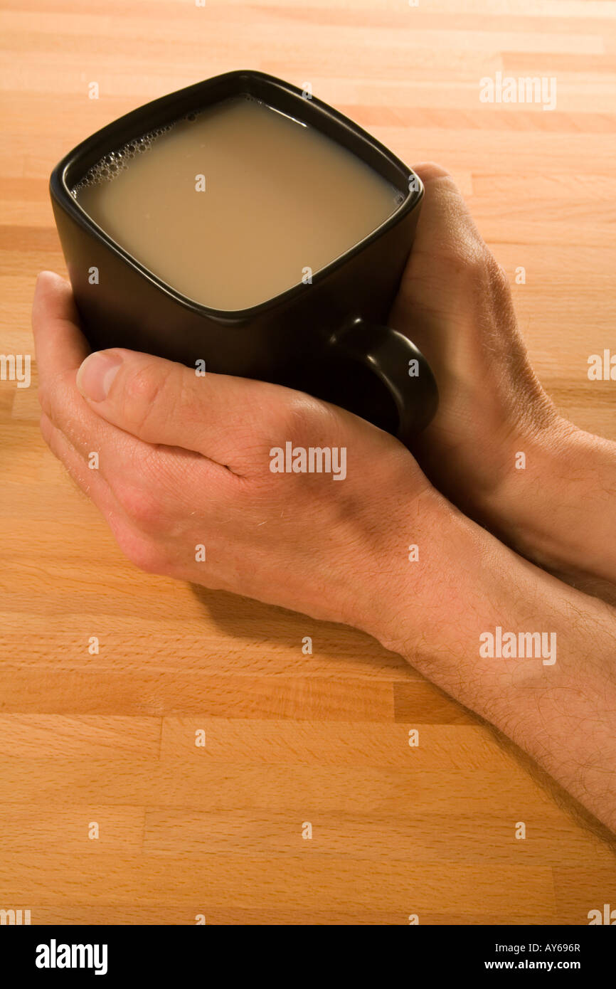 Hands around cup hi-res stock photography and images - Alamy